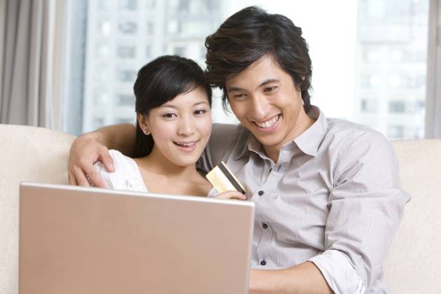 Chinese couple cuddling on a sofa Beijing China