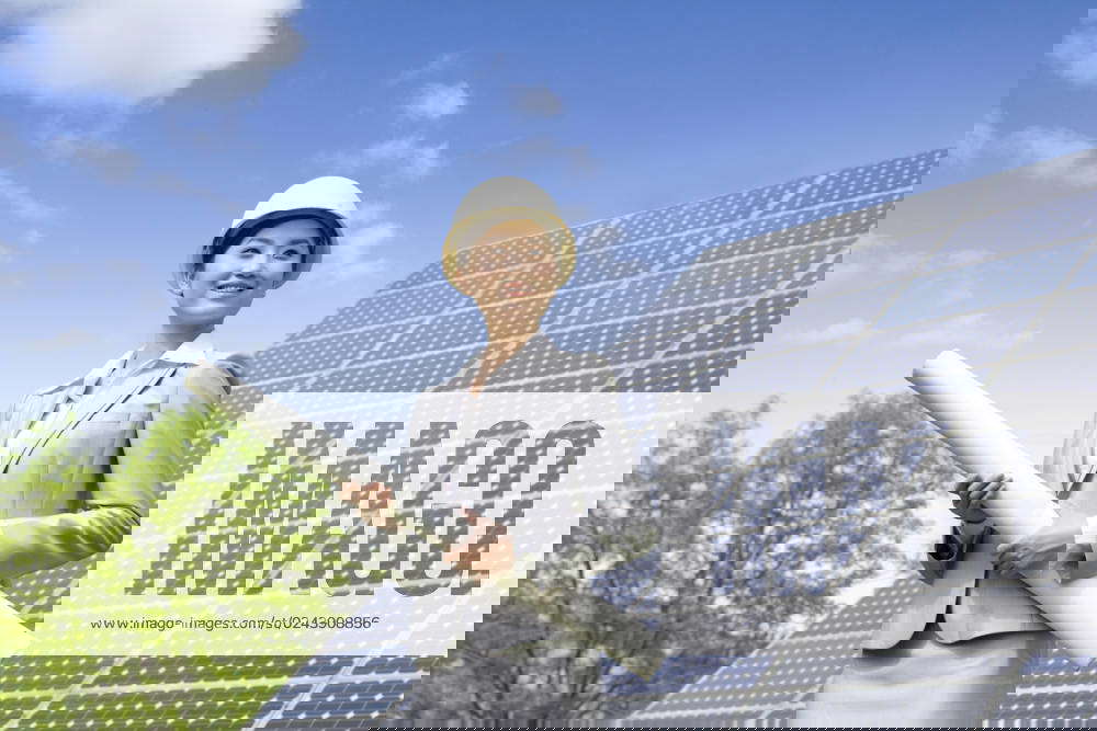 Portrait of a Chinese engineer in front of solar panels Beijing China