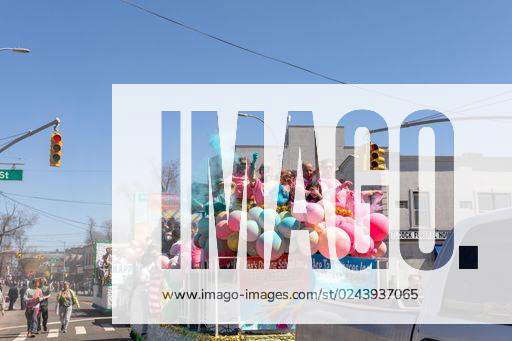 A group of diverse people spreading color powder on each other at the ...