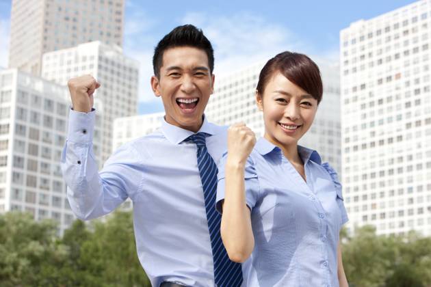 Chinese colleagues standing cheering together Beijing China