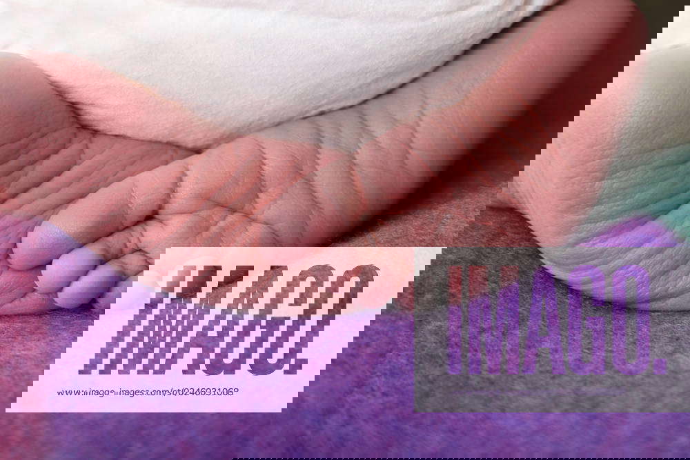 Curled up feet of a newborn baby