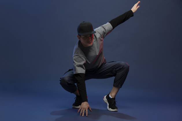Studio shot of fashionable young Chinese man dancing Beijing China