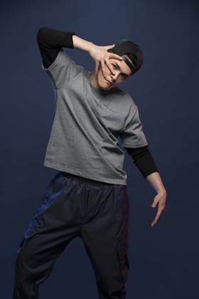Studio shot of fashionable young Chinese man dancing Beijing China