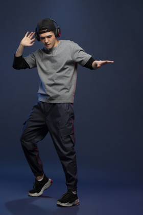 Studio shot of fashionable young Chinese man dancing Beijing China