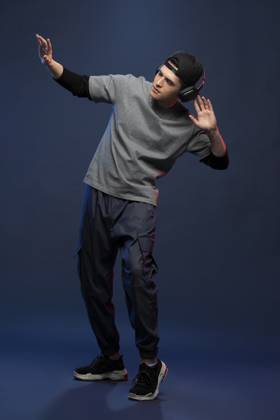 Studio shot of fashionable young Chinese man dancing Beijing China