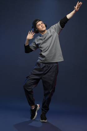 Studio shot of fashionable young Chinese man dancing Beijing China