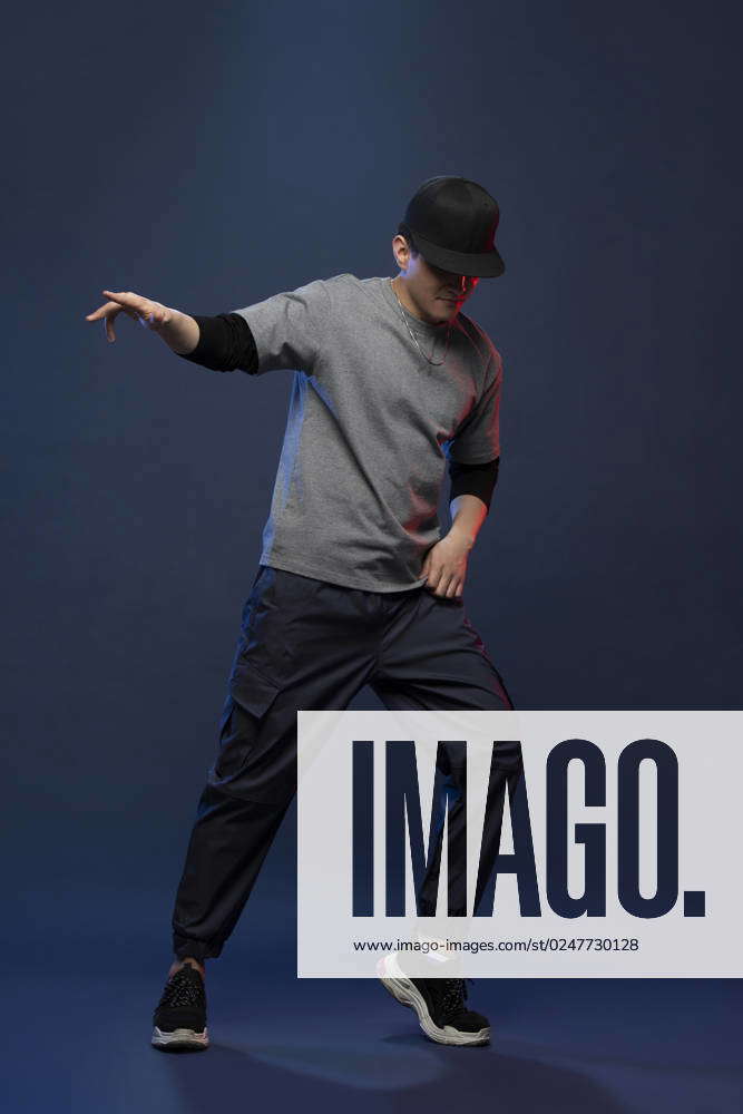 Studio shot of fashionable young Chinese man dancing Beijing China