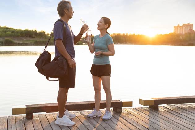 Happy mature Chinese couple having a rest after exercising Beijing China