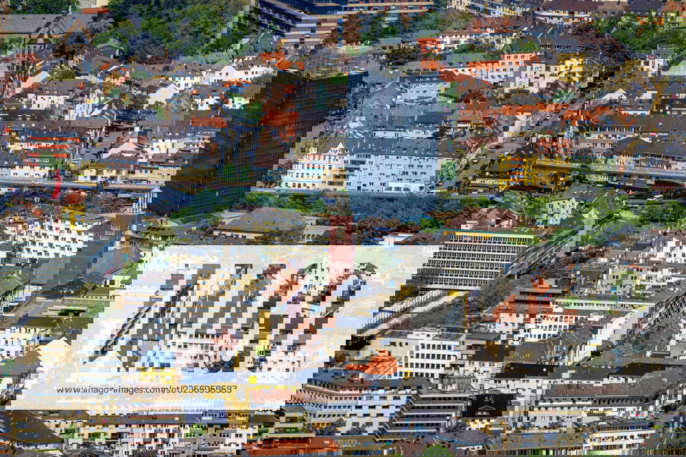 Aerial view, roof work on labor office high-rise, church tower of ...