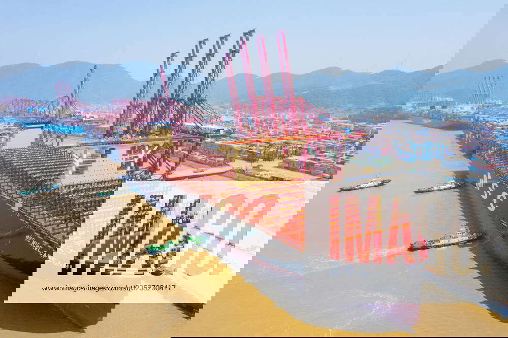 NINGBO, CHINA - JUNE 02: Aerial view of tugboats pushing MSC Michel ...