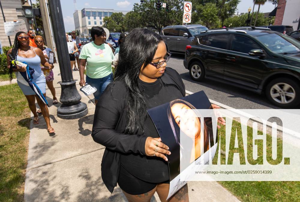 Syndication: Ocala StarBanner Alyaa Franks carried a portrait of Ajike ...