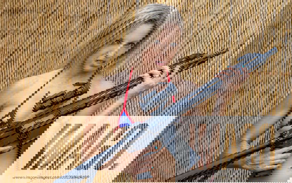 A Lovely Fitness Model Shows Off Her Assault Rifle Wearing A Patriotic Bikini A beautiful fit