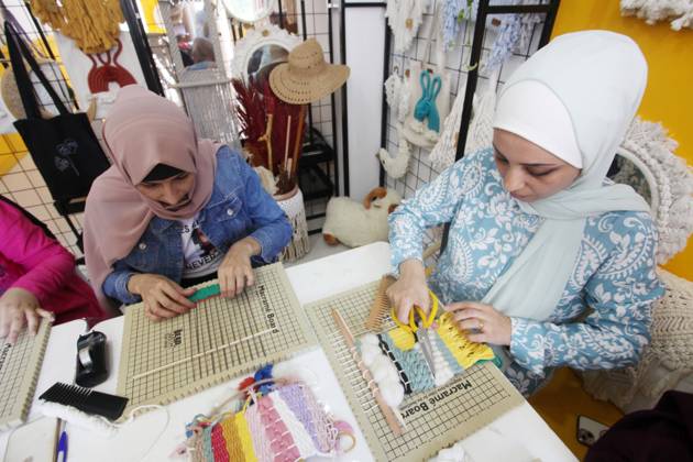 Palestinian girls learn the handicrafts such as weaving and wooden loom ...