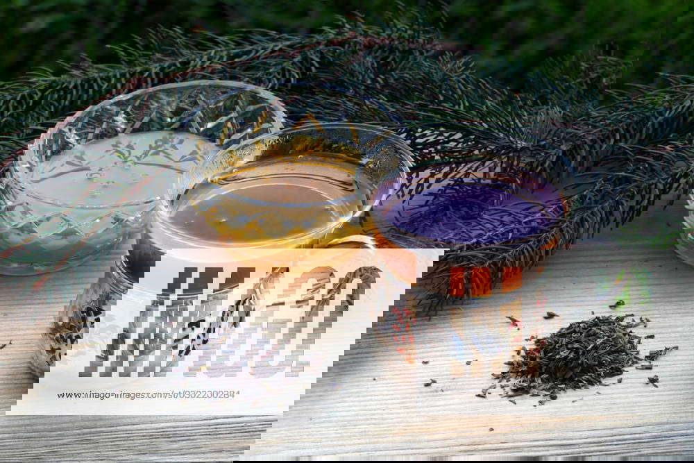 Tea and honey in nostalgic glasses and some loose tea, n an old wooden ...