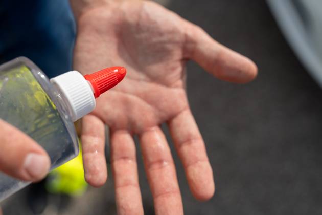 15 August 2023: Hands of a climate activist holding a bottle of ...