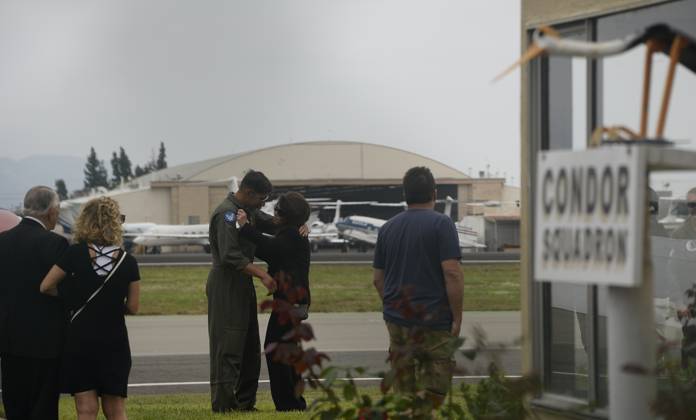 The wife of President Chris Rushing hugs friends at the Condor Squadron ...