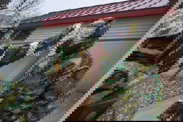 U.S. Air National Guard Staff Sgt. Gillian Watkins, left, personnel ...