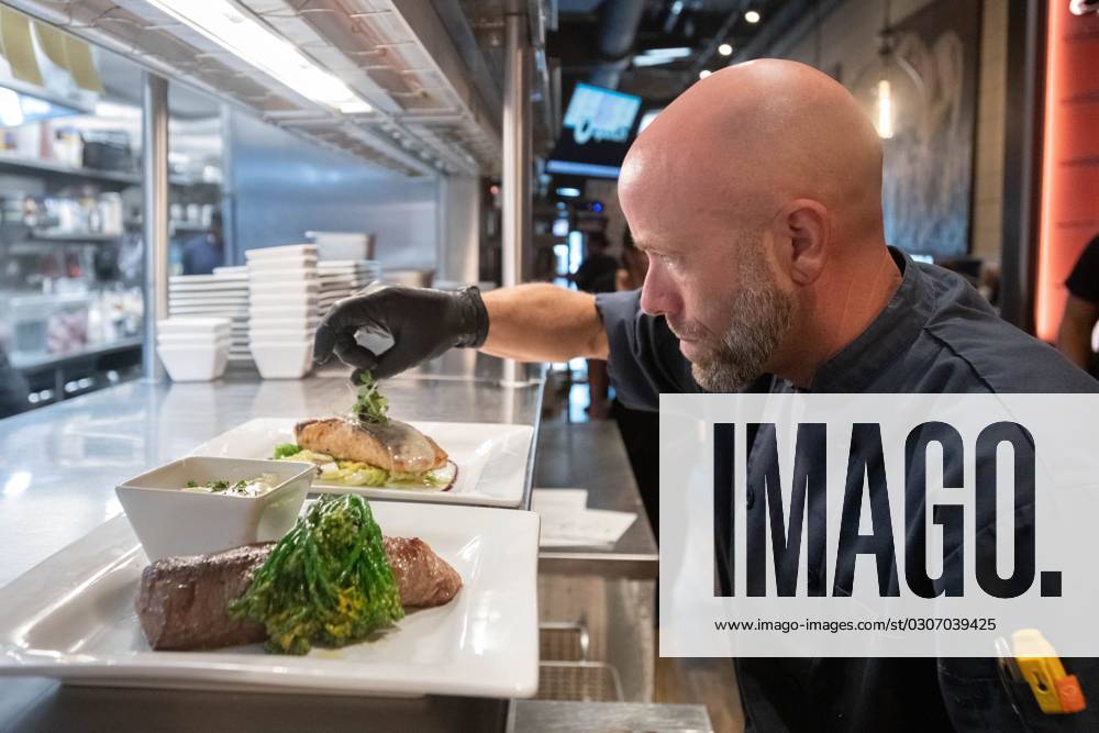 Syndication: News-Journal Executive chef Jacob Childers garnishes a ...