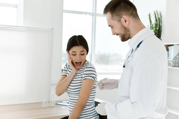 Emotional woman afraid of injections vaccination hospital treatment ...