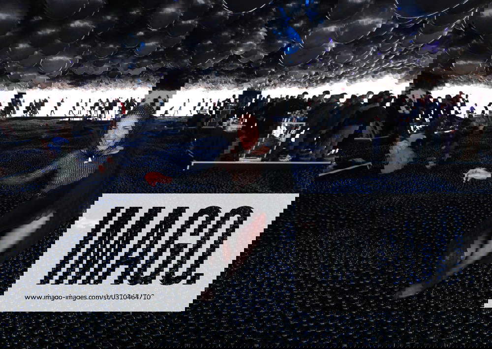 Guests jump into the ball pit when they attend the opening night event ...