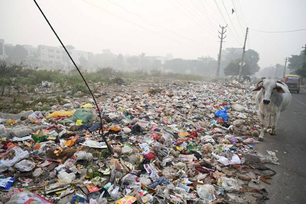 GURUGRAM, INDIA - NOVEMBER 5: Garbage spread on a road in sector-5 due to MCG sanitation workers