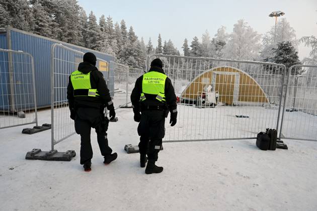 Finnish border guards at the entrance to the migrants arched depot at ...