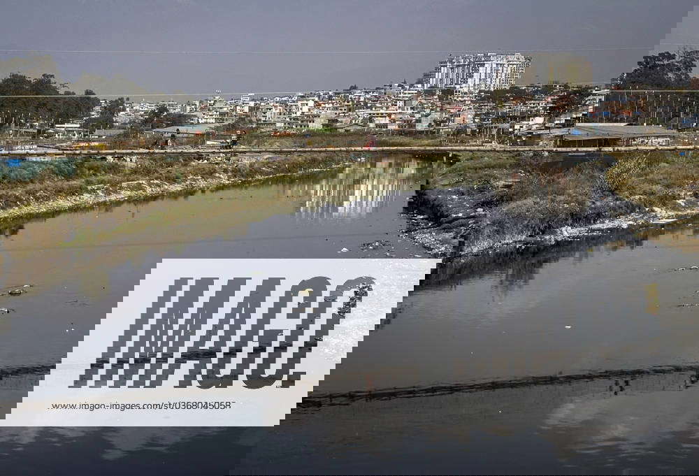 Kirtipur, Bagmati, Nepal: People walk on the suspension bridge above ...