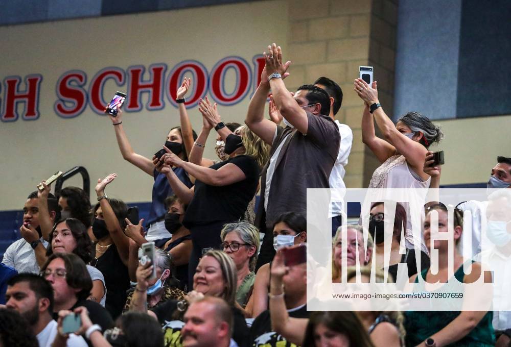 Syndication: Desert Sun, Family members and friends stand and cheer for ...