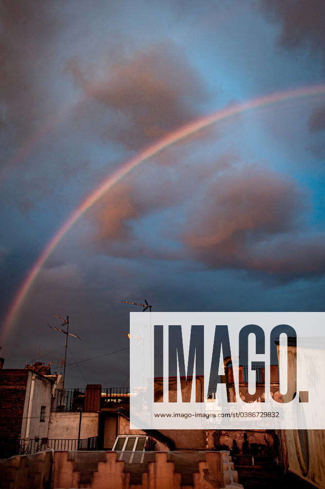 Barcelona, Spain: A rainbow forms over the rooftops of Barcelona s old ...