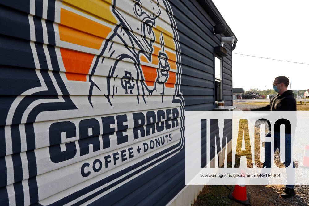 Syndication: Online Athens, A customer grabs coffees from Cafe Racer in ...