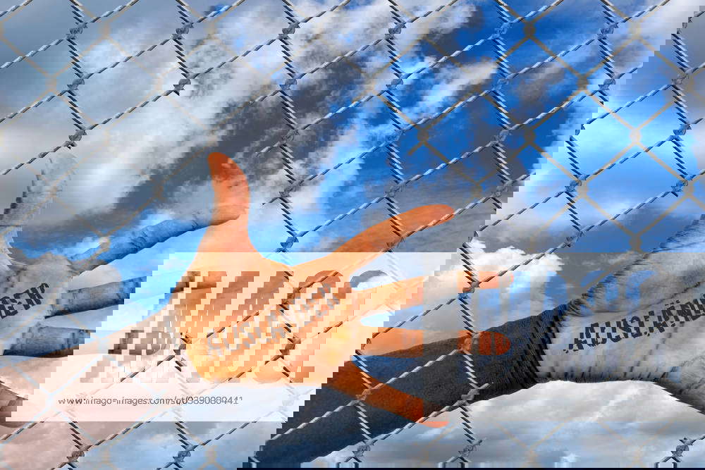 the Hand one Foreigners behind a Chain link fence, Hole, Loophole, Help ...