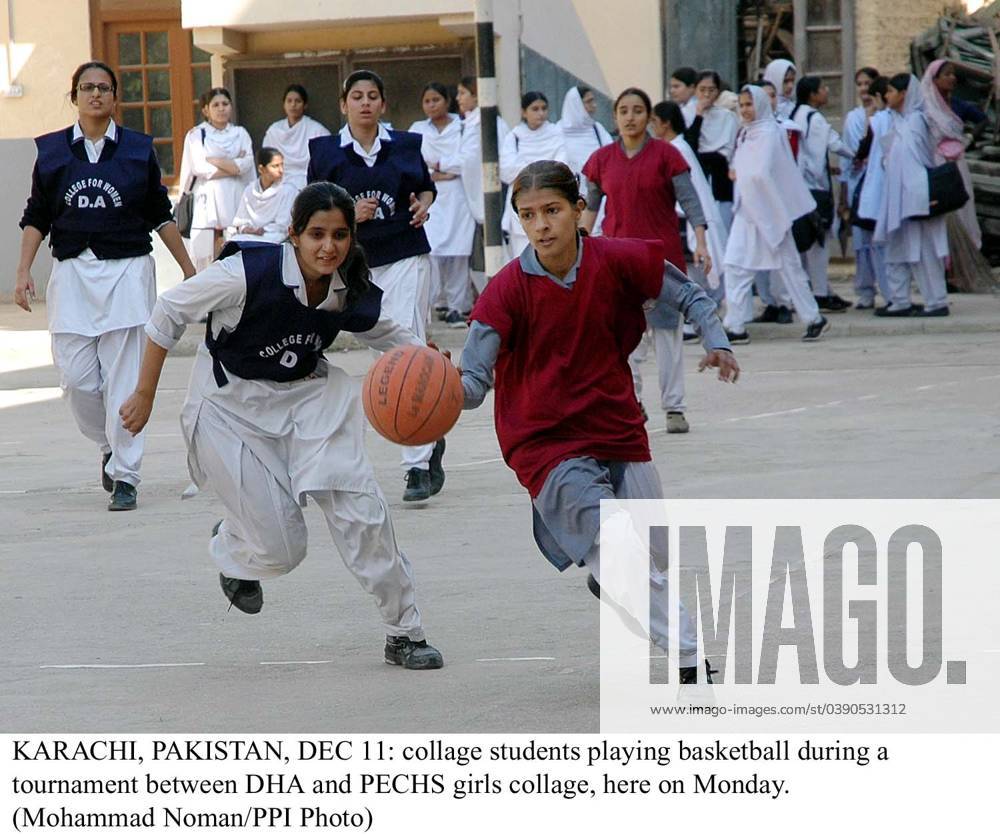 KARACHI, PAKISTAN, DEC 11: collage students playing basketball during a ...