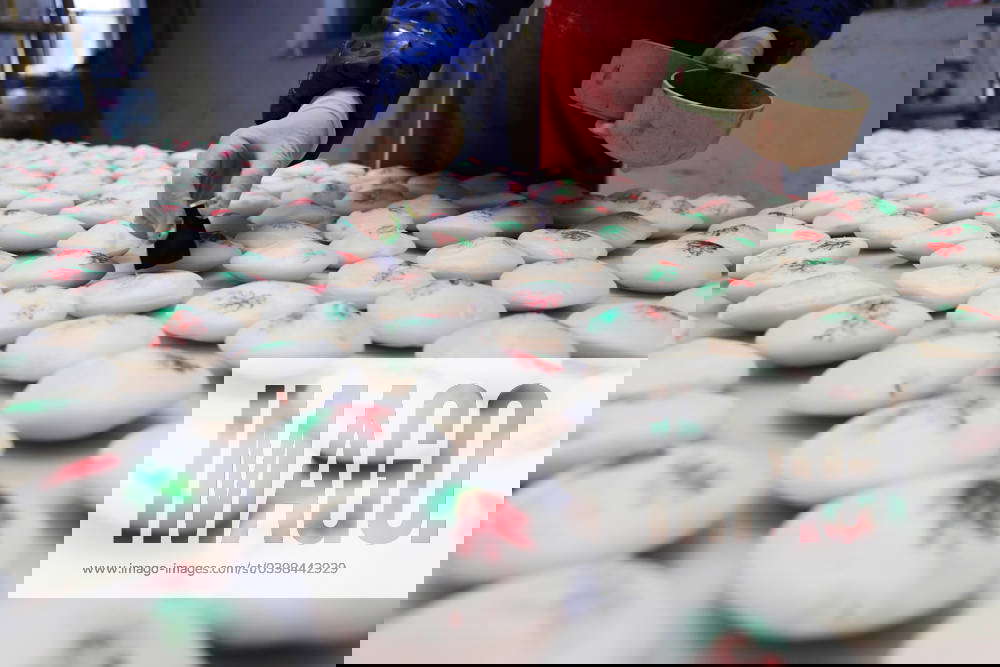 CHONGQING, CHINA - FEBRUARY 01: A woman makes Ciba, or glutinous rice ...