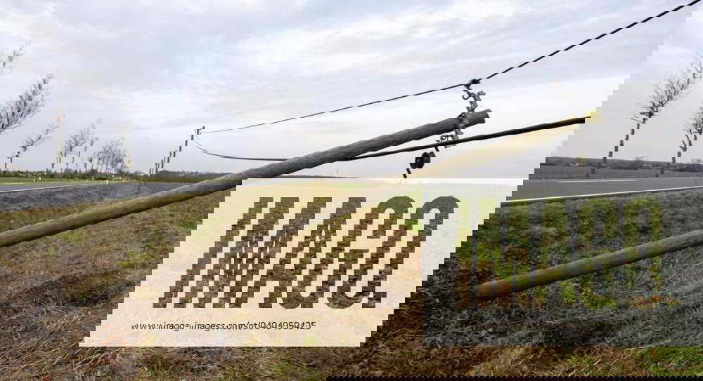 Broken pylon A broken electricity pylon lies in the ditch near ...