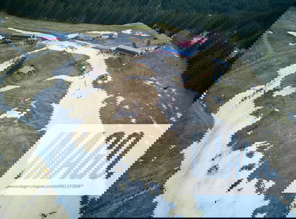 Alpine skiing on the ski slope in warm temperatures and lack of snow at ...