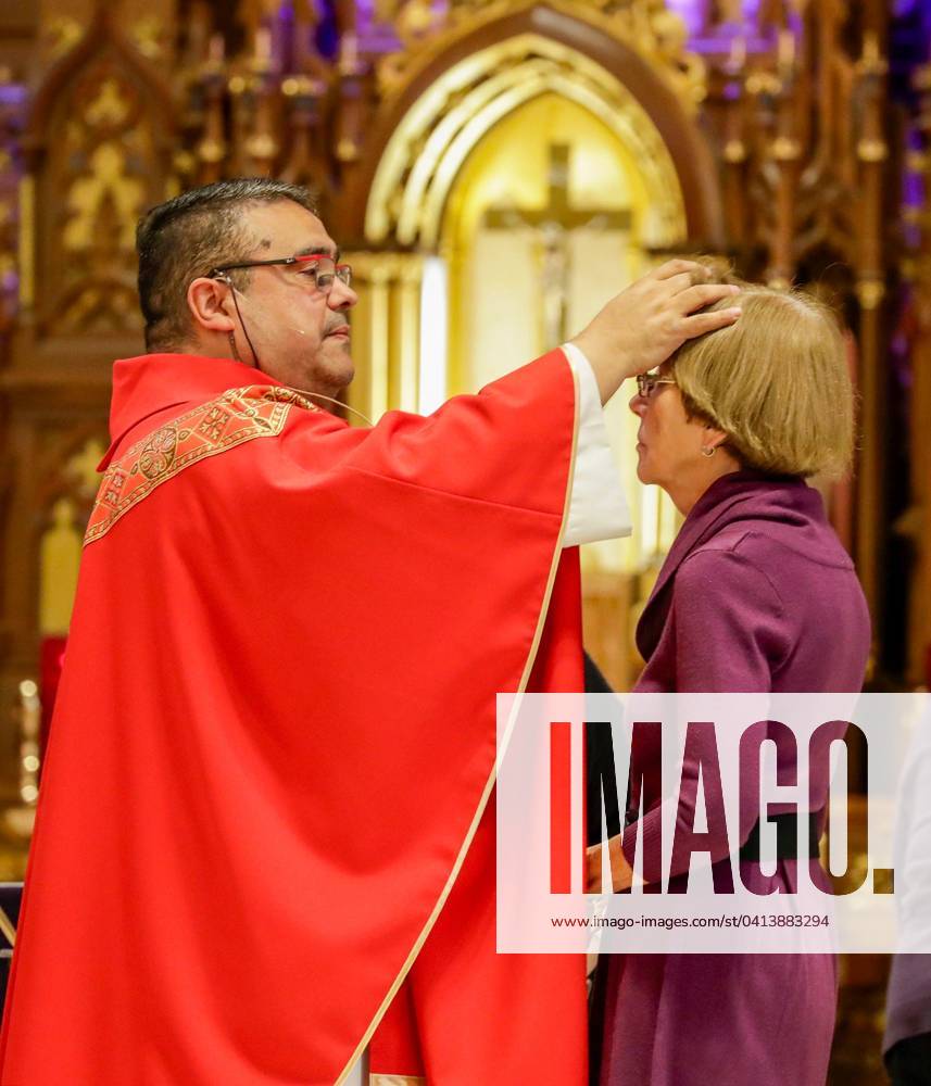 Syndication: Sheboygan Press Father Norberto Sandoval places ashes upon the forehead of a Holy Name