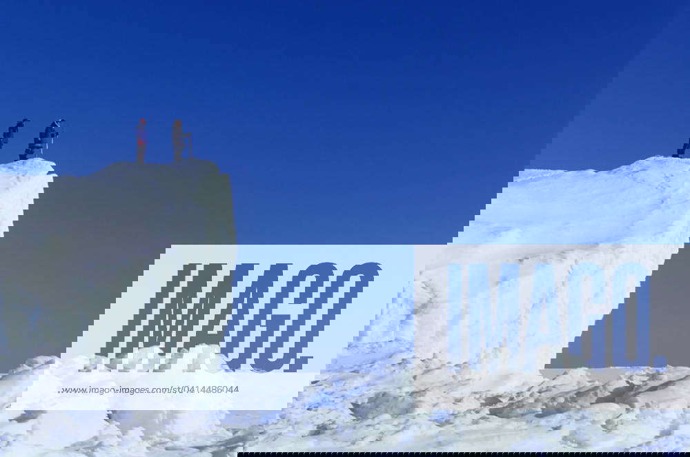 Inuit guide and client on iceberg frozen in sea ice, Kimmirut, Baffin ...