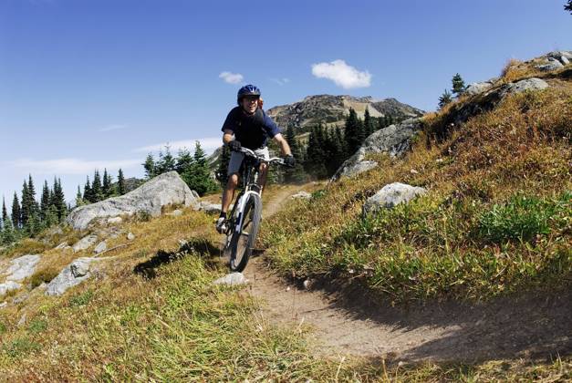 Man riding a mountain bike on Whistler Mountain, British Columbia