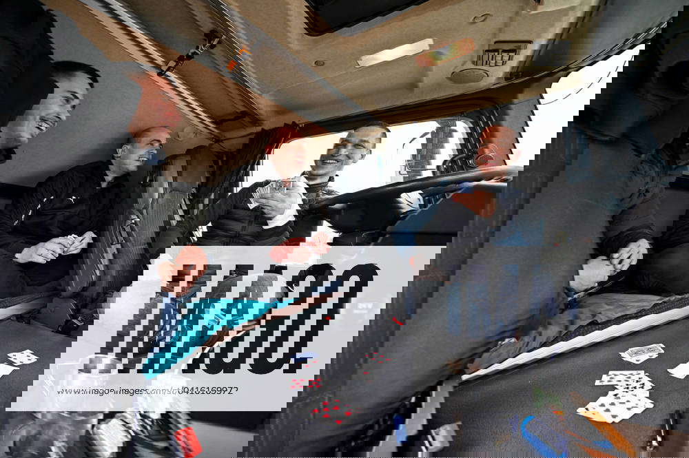 LVIV REGION, UKRAINE - FEBRUARY 22, 2024 - Drivers share a laugh while ...