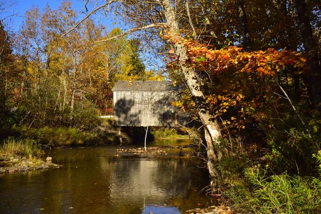 A side view of the iconic wooden covered bridge spanning the Trout ...