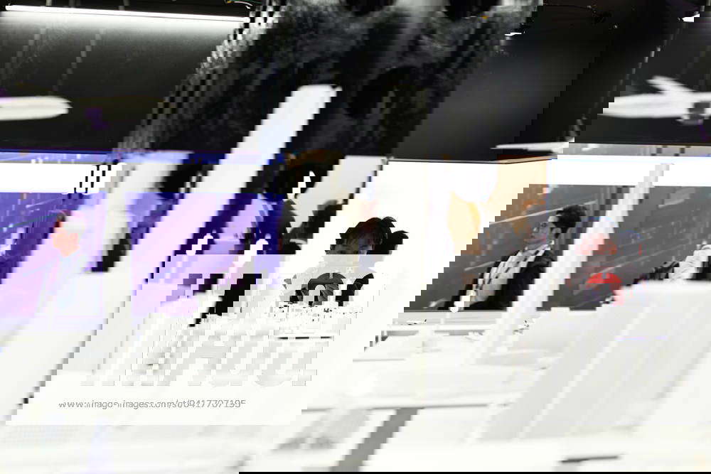 MWC Barcelona 2024 in Spain - 26 Feb 2024 A man takes photos of a booth ...