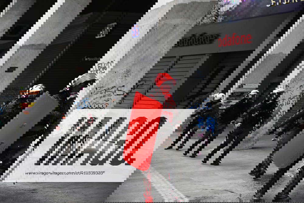 Riot police officer covered in red paint walks along with other ...