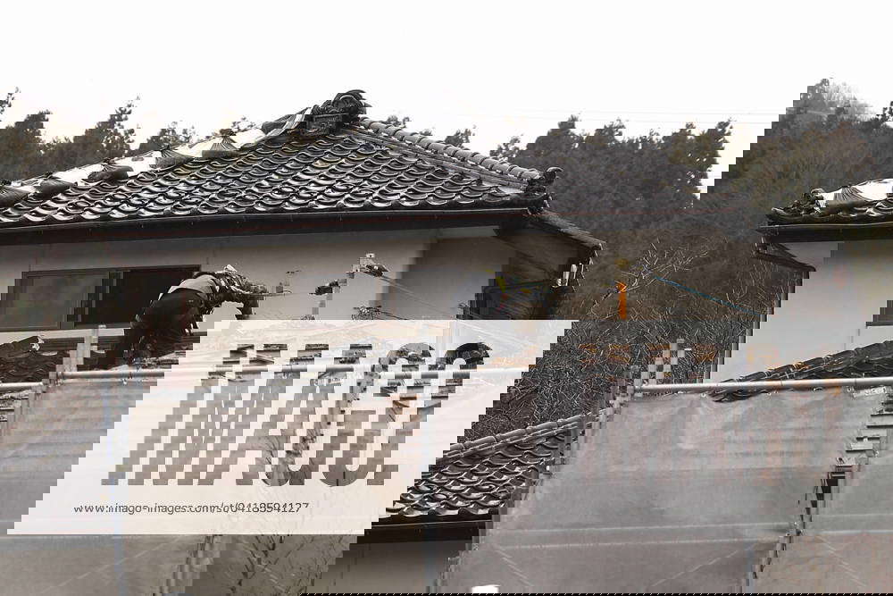 Namie, Fukushima, Japan: Construction workers demolish an abandoned ...