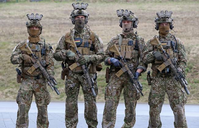 A KSK Special Forces Command Troop hands an injured person to the crew ...