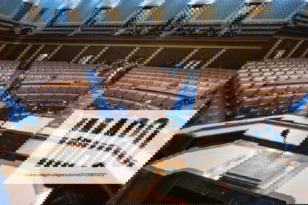 President Joe Biden, back center, departs a nearly empty House chamber ...