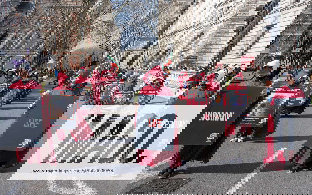 March 8, 2024, London, United Kingdom: Protesters hold placards and ...