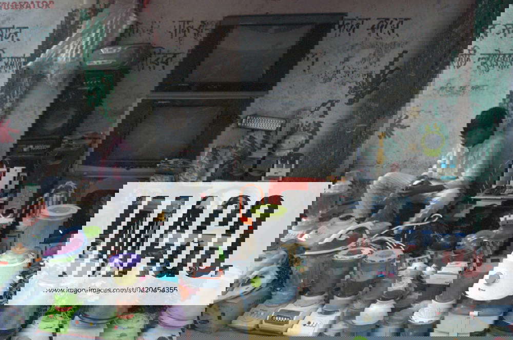 March 14, 2024, Dhaka, Bangladesh: A vendor waits for customers as he sells second-hand electronic