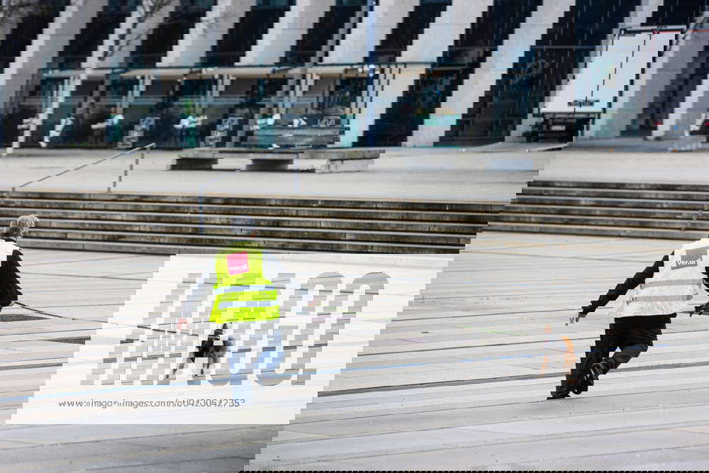 A strike participant with his dog in front of the airport terminal ...