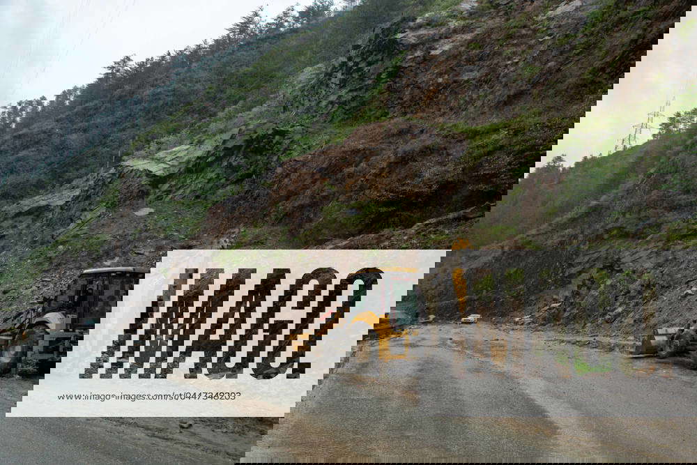 Ramban, Jammu & Kashmir, India: A JCB works along a highway at Banihal ...