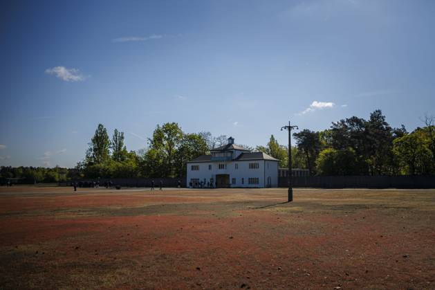 Flowers grow on the former roll call square at the Sachsenhausen ...